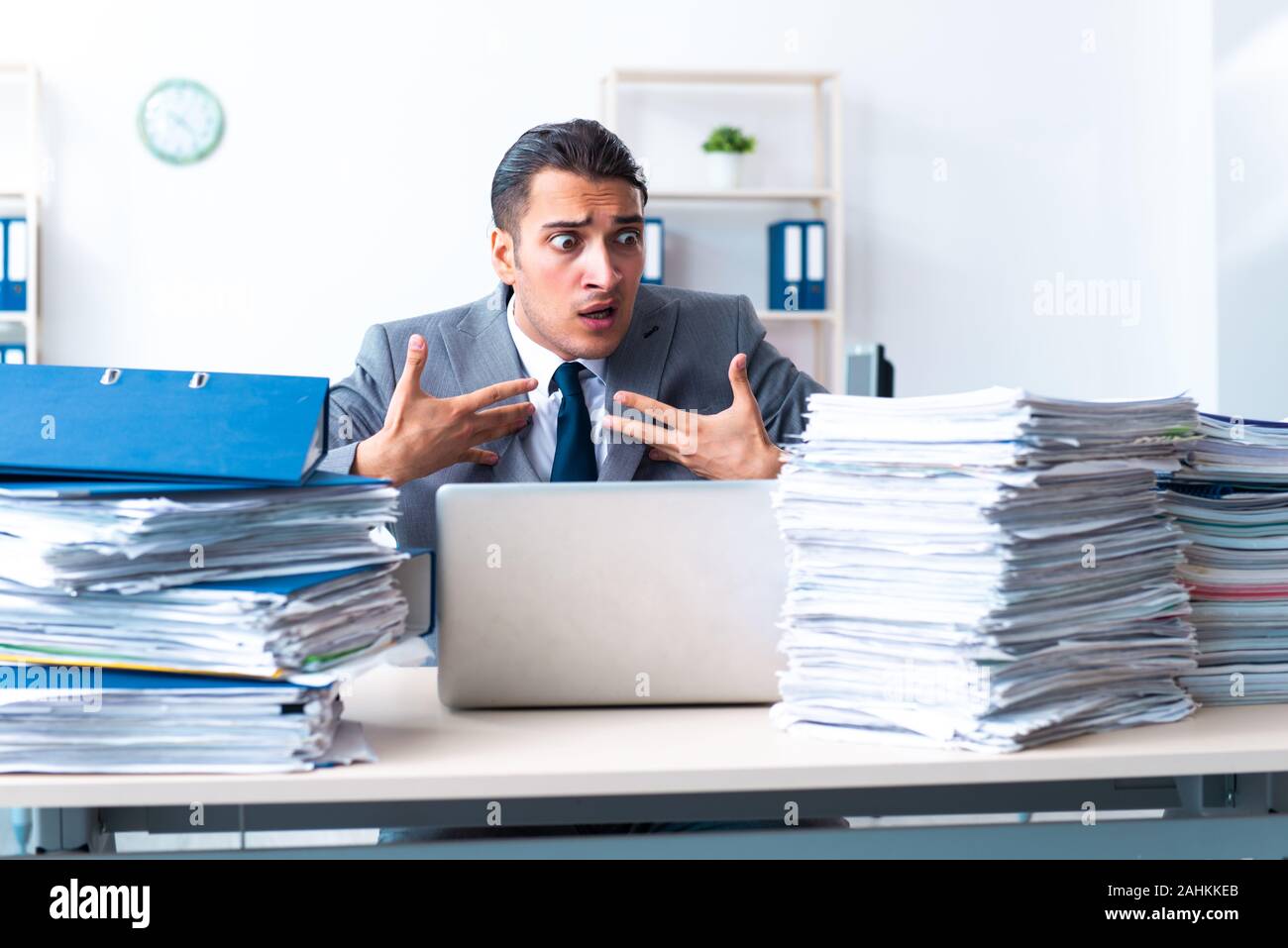 The businessman with heavy paperwork workload Stock Photo - Alamy