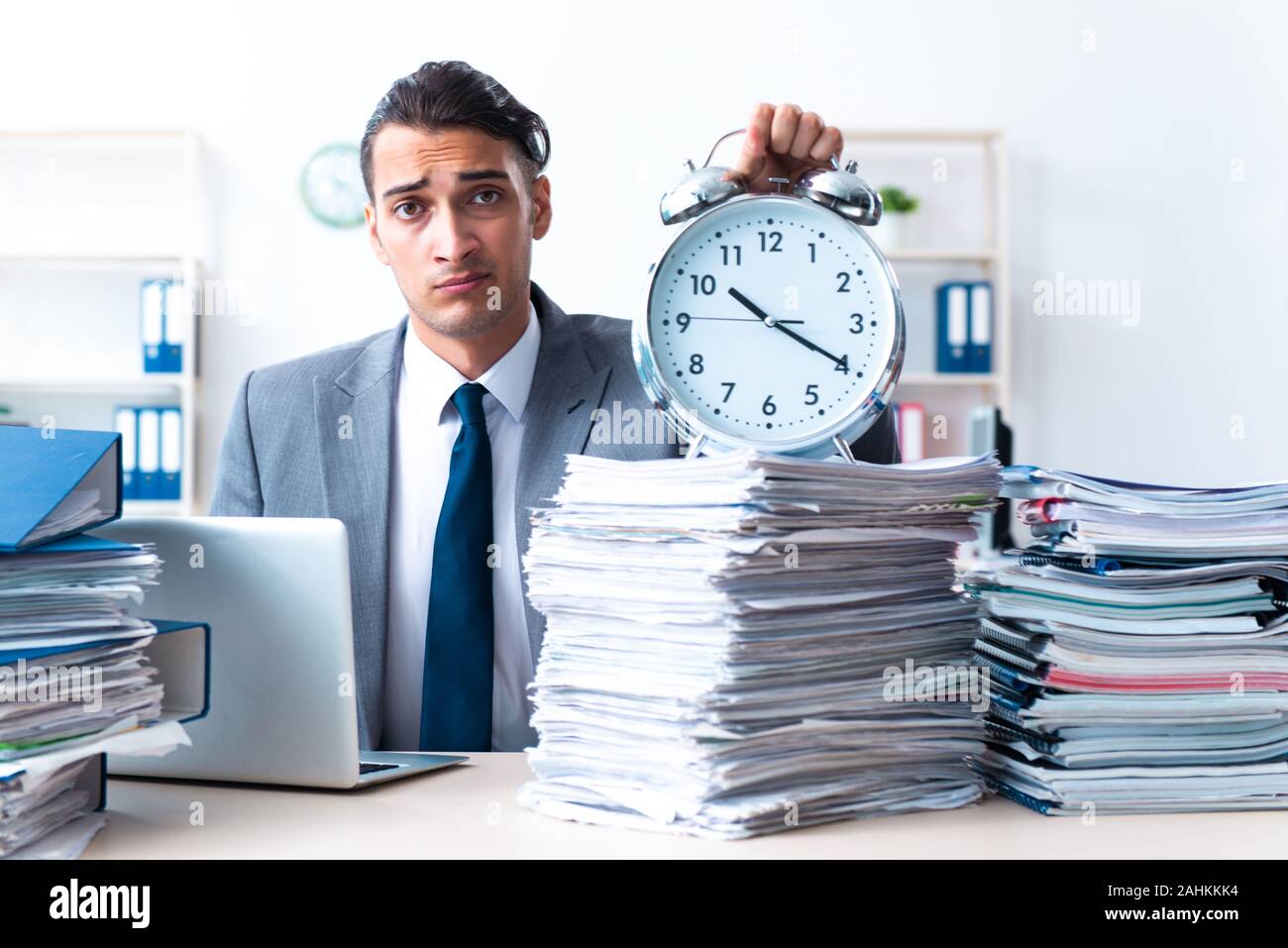 The businessman with heavy paperwork workload Stock Photo - Alamy