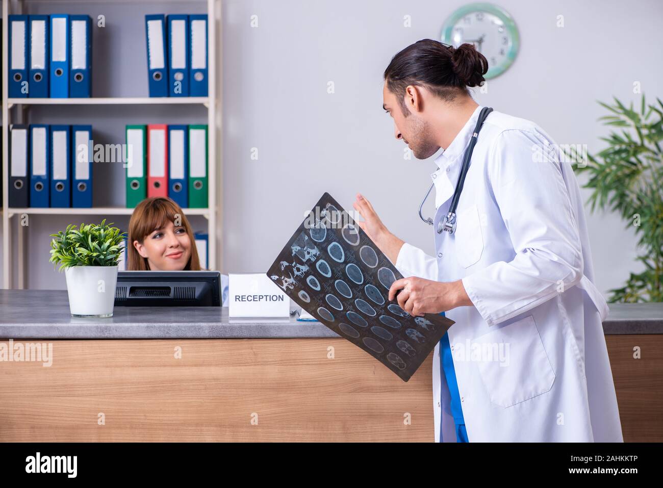 The two doctors working at the reception in the hospital Stock Photo ...