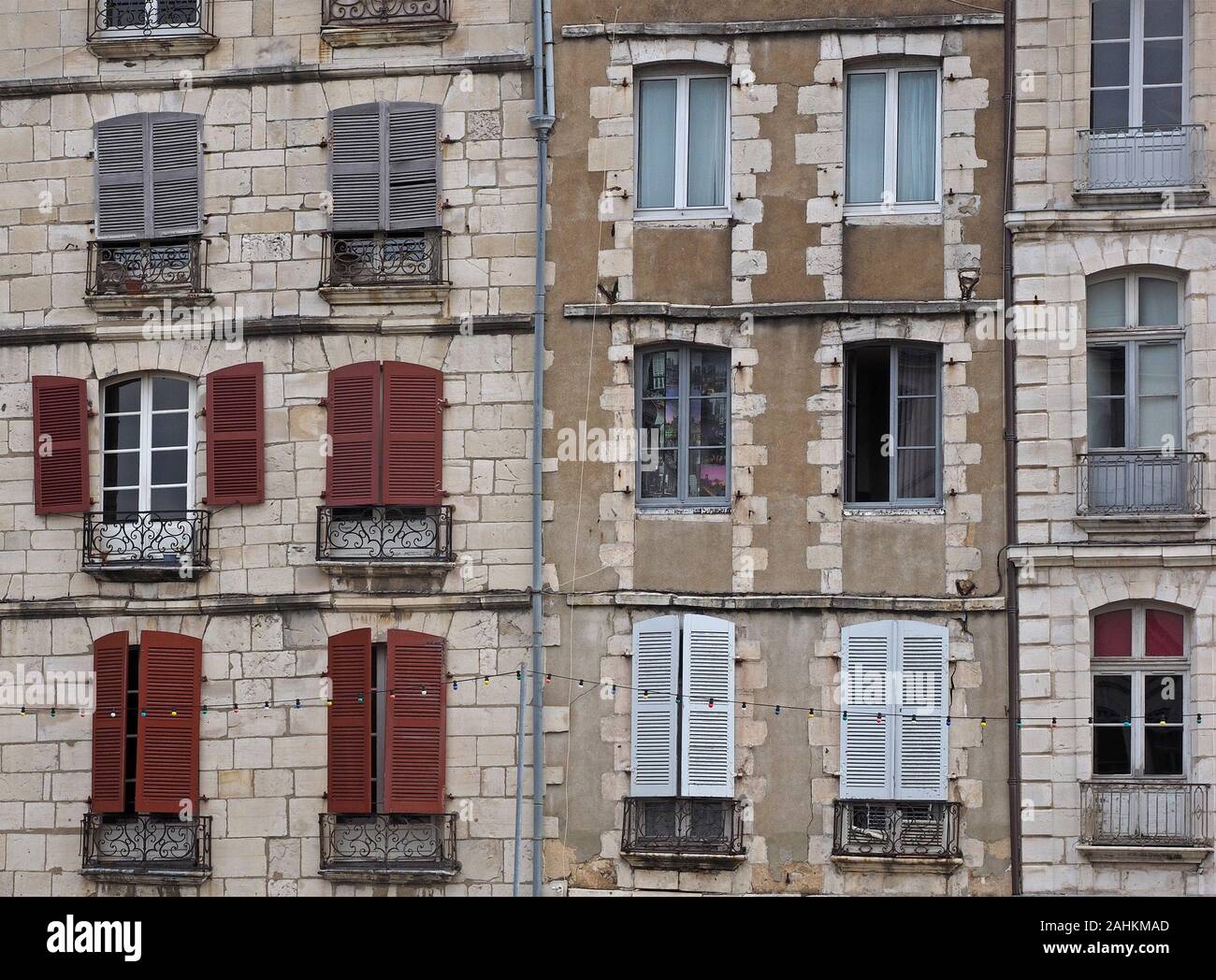 faded colours of vernacular buildings overlooking river in French ...
