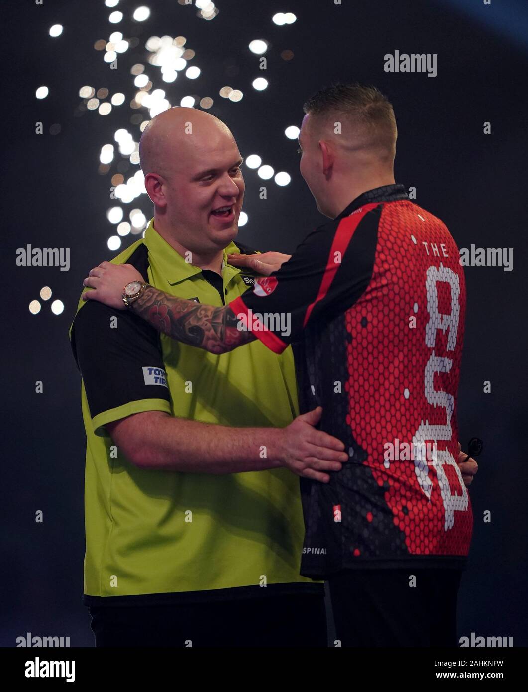 Michael van Gerwen (left) and Nathan Aspinall shake hands at the end of ...