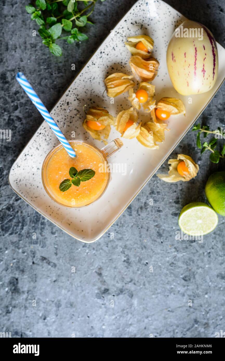 Healthy drink pepino melon and golden berry smoothie in a glass jar ...