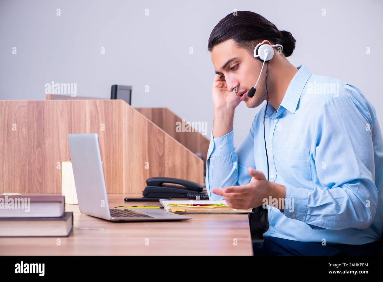 The call center operator working at his desk Stock Photo - Alamy
