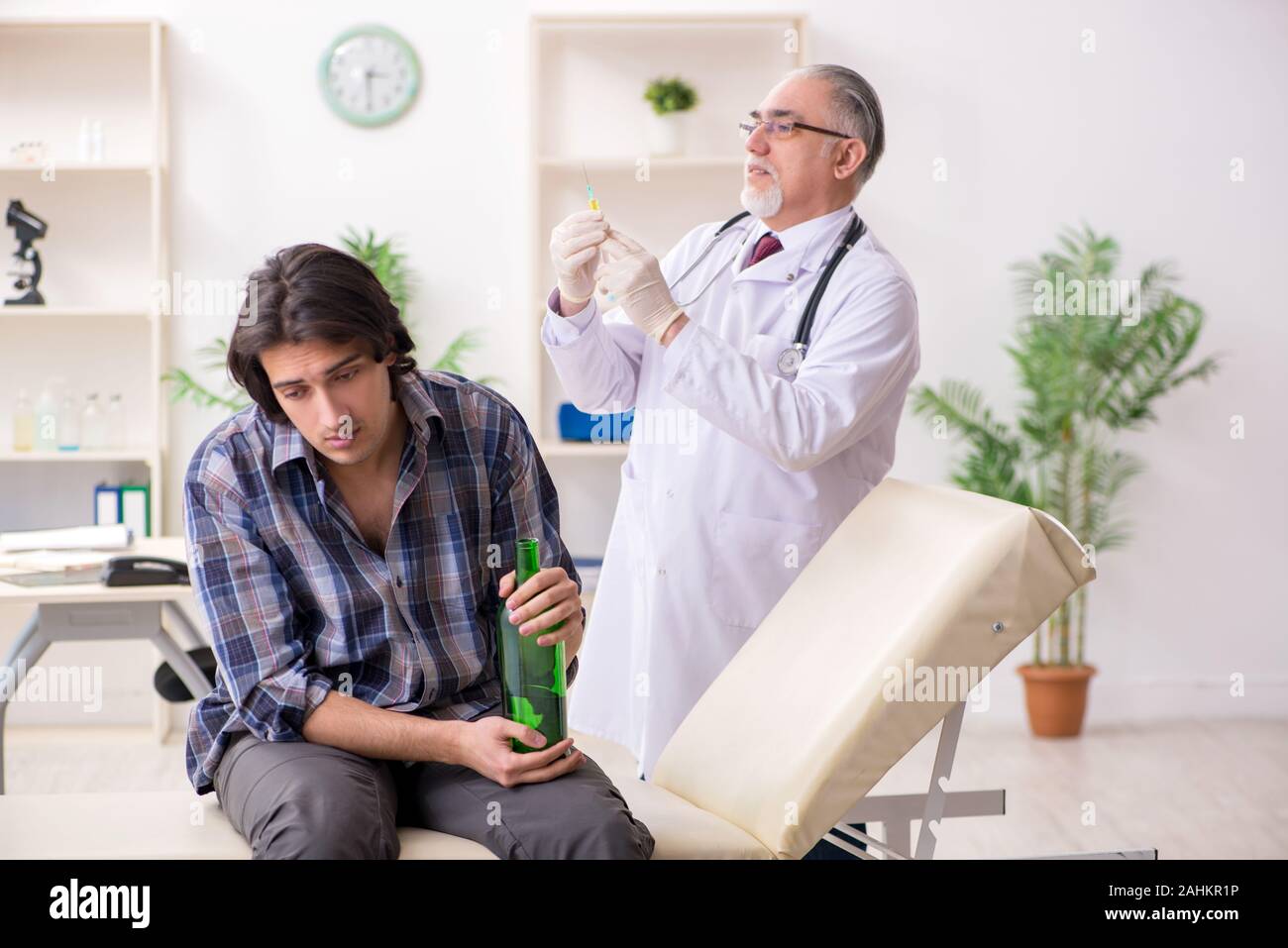 The young male alcoholic visiting old doctor Stock Photo - Alamy