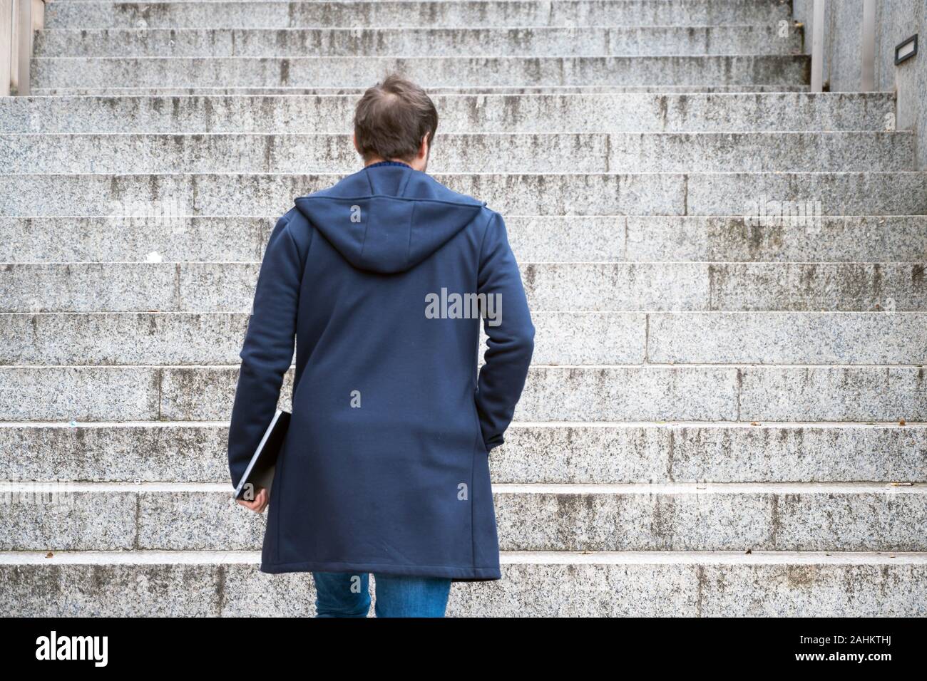 Young man Holding Computer Laptop Walking Up Stairs outdoor Stock Photo ...