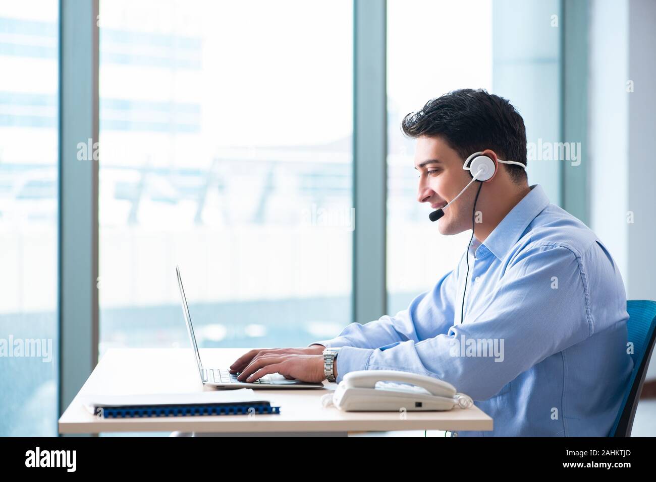 The male call-center operator in business concept Stock Photo - Alamy