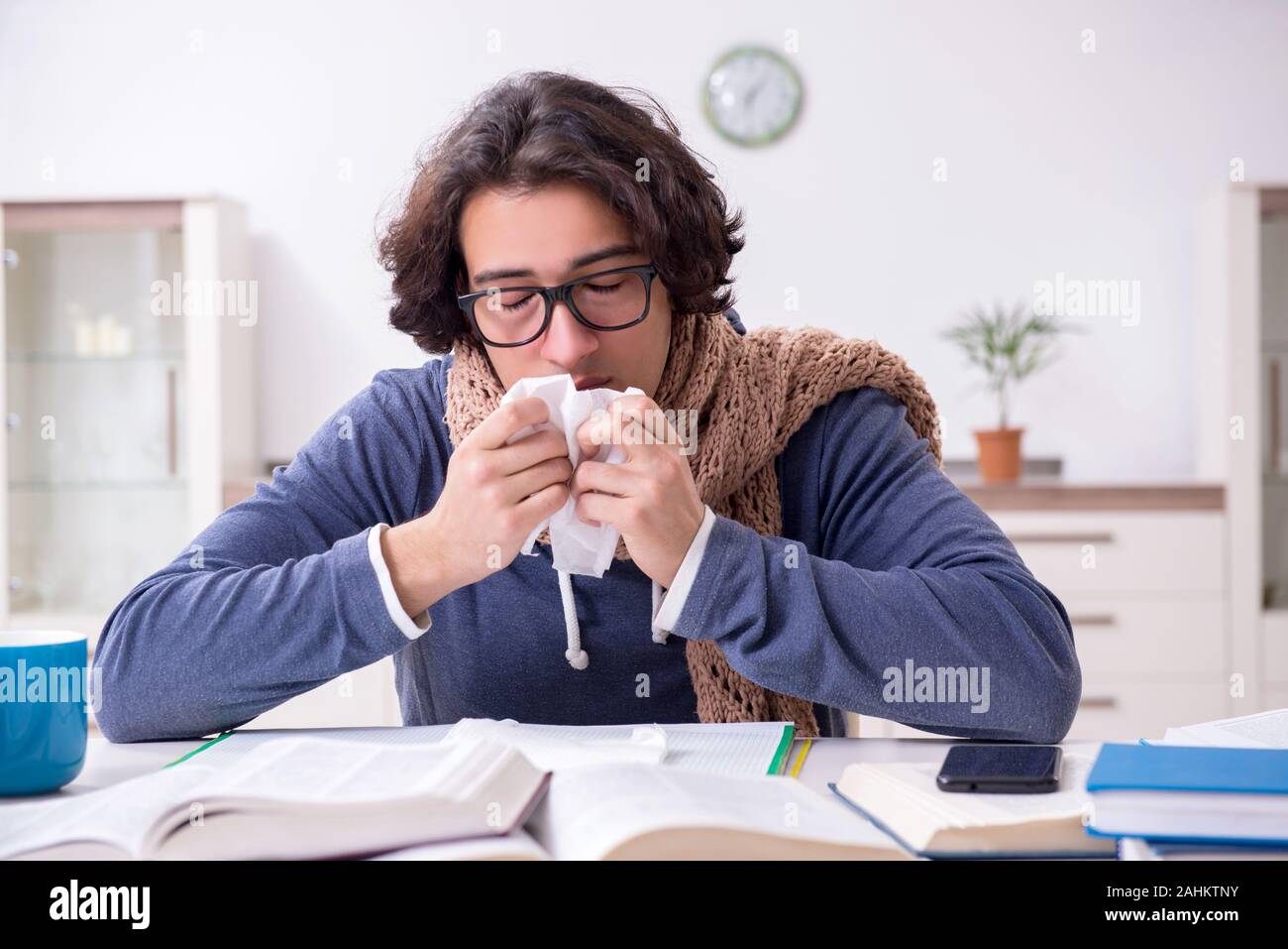 The sick male student suffering at home Stock Photo - Alamy
