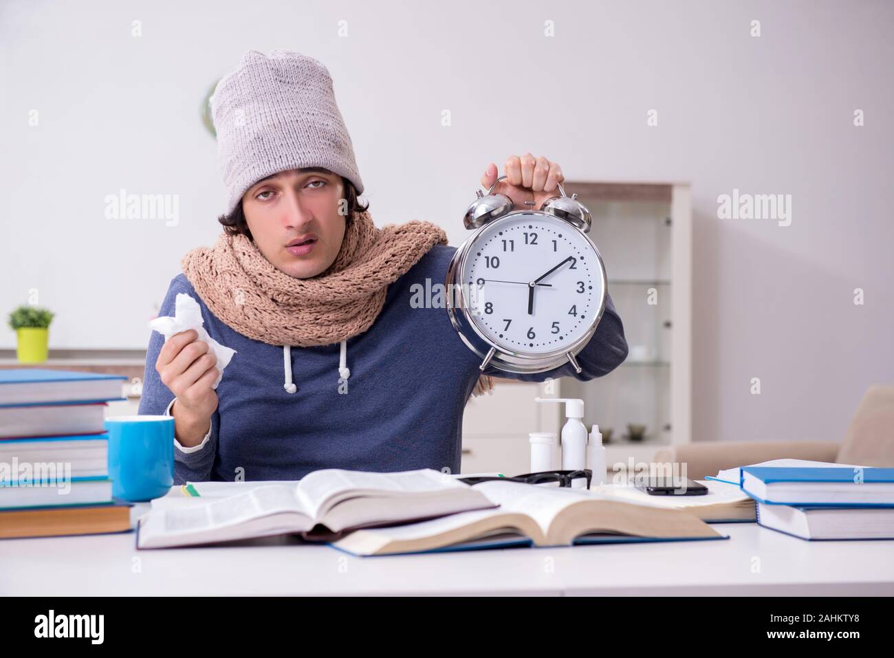 The sick male student suffering at home Stock Photo - Alamy
