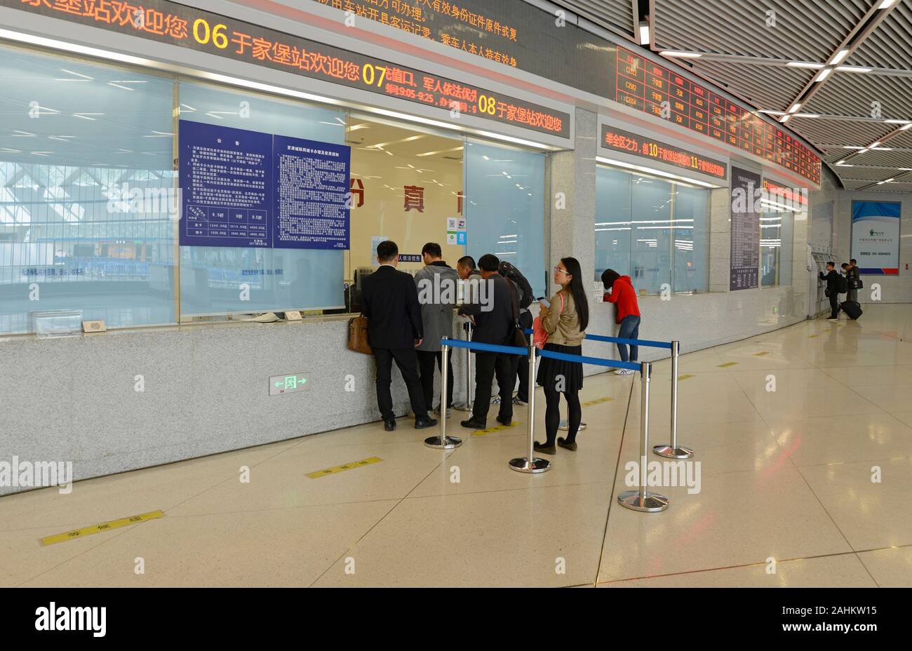Passengers queue to buy tickets at the ticket office in Yujiabao high ...