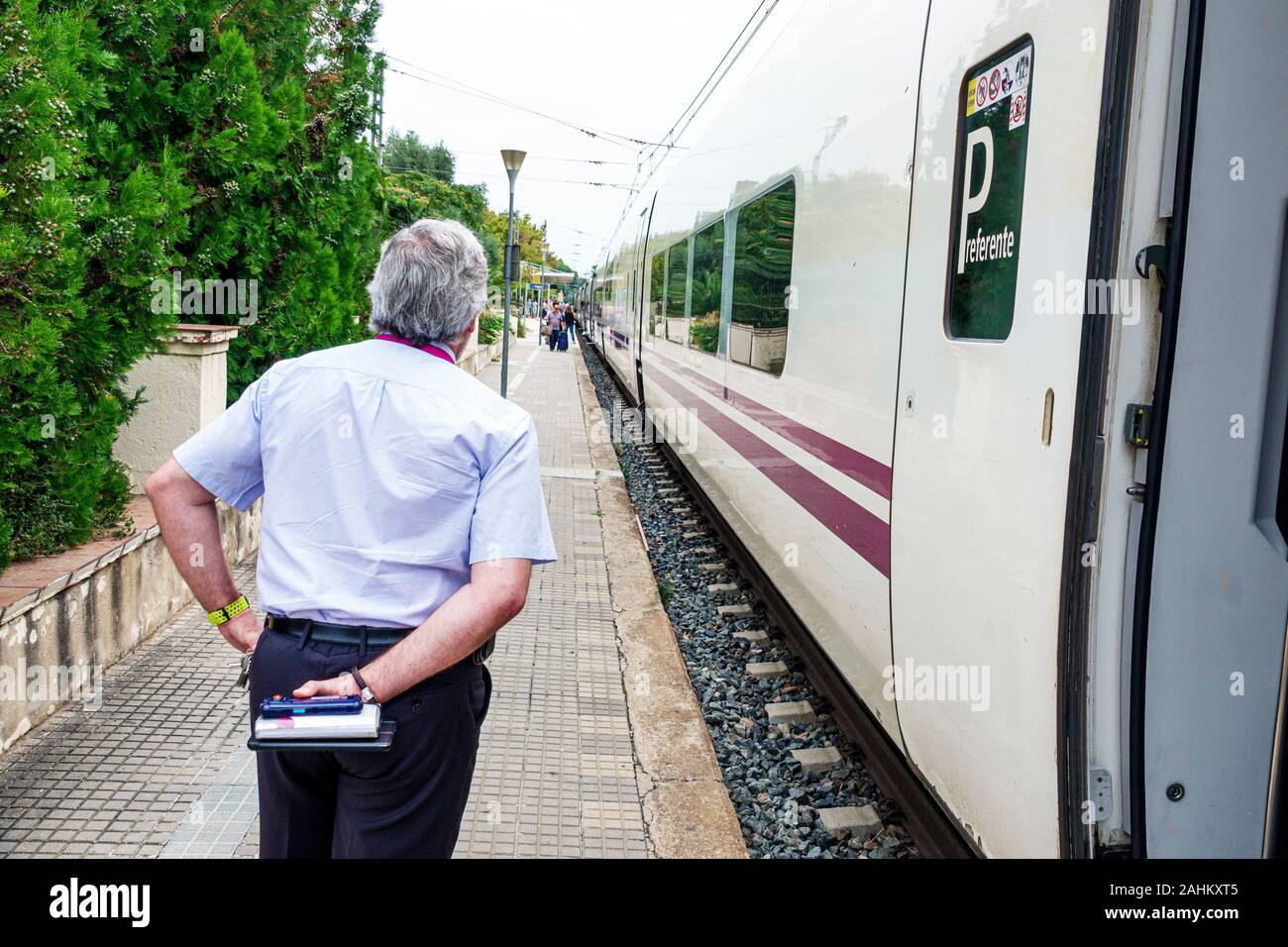 Spain,Catalonia Salou,Renfe train railway station,platform,conductor ...