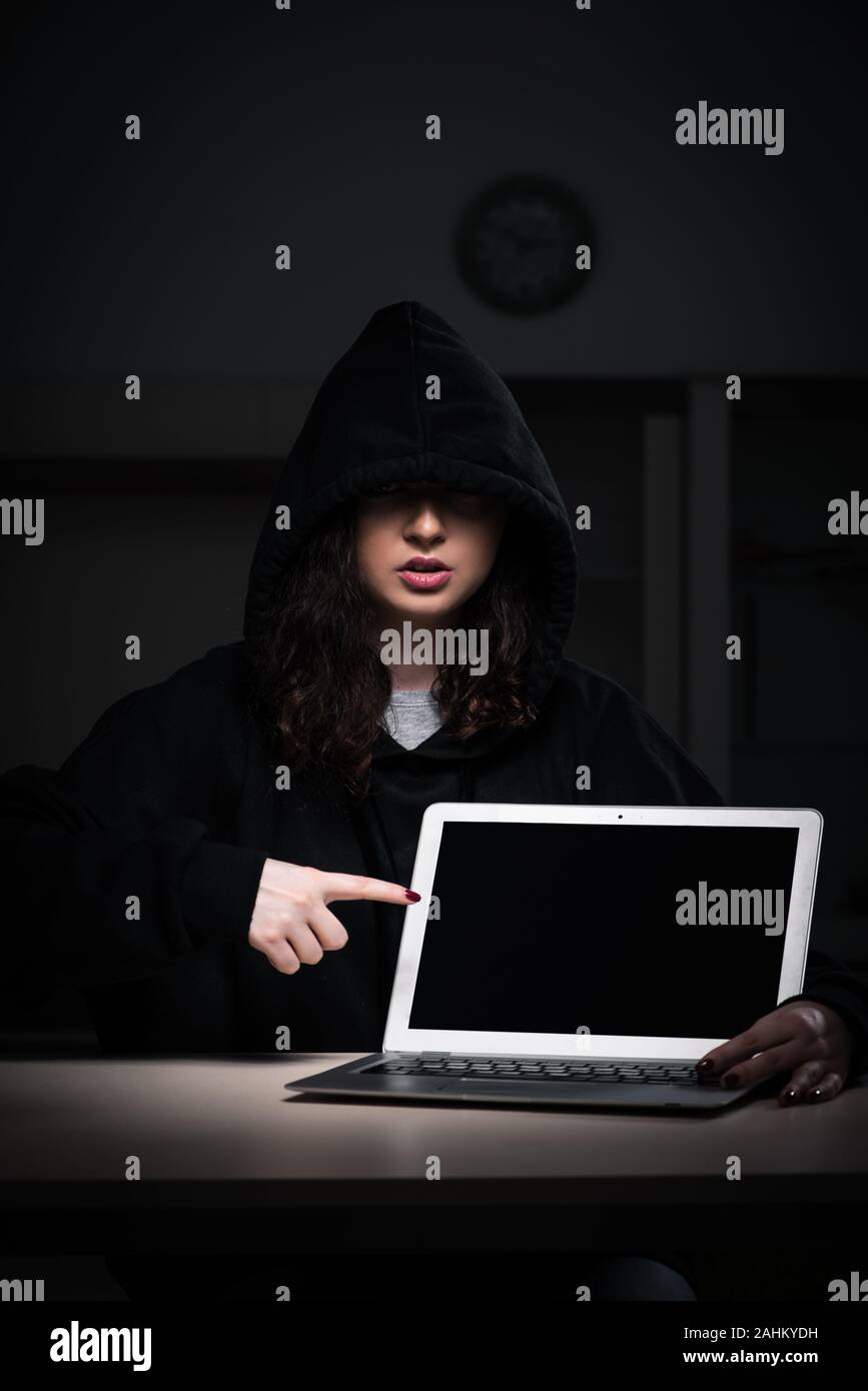 The female hacker hacking security firewall late in office Stock Photo ...