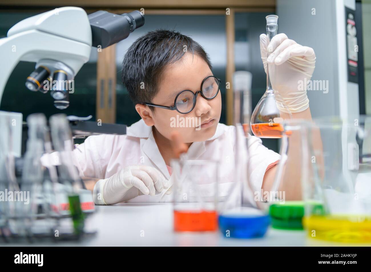 Kid scientist making experiment in chemical laboratory, ecucation and ...