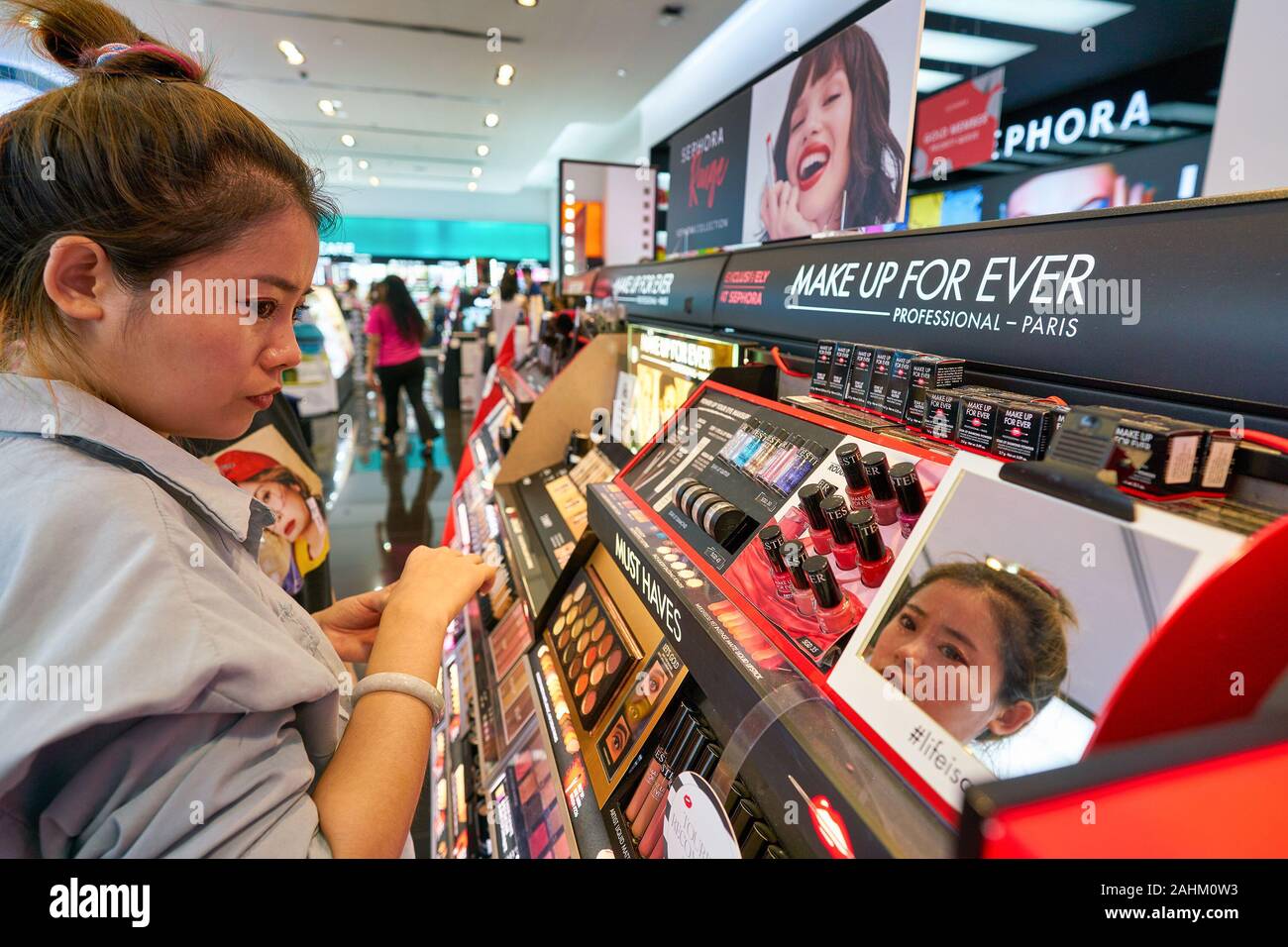 SINGAPORE - APRIL 03, 2019: woman shopping for cosmetics products at ...