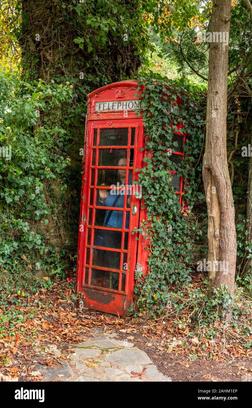 Woman trapped inside a red traditional telephone box in England Stock ...