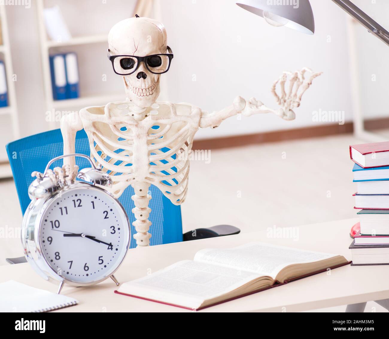 The skeleton businessman working in the office Stock Photo - Alamy