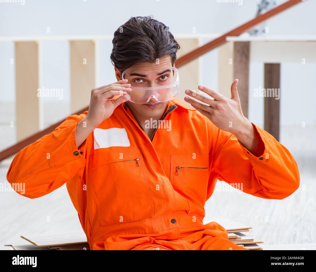 The worker wearing protective goggles at construction site Stock Photo ...