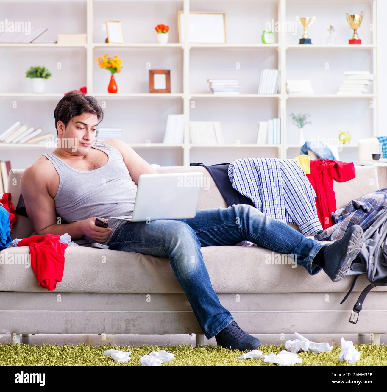 The young man working studying in messy room Stock Photo - Alamy