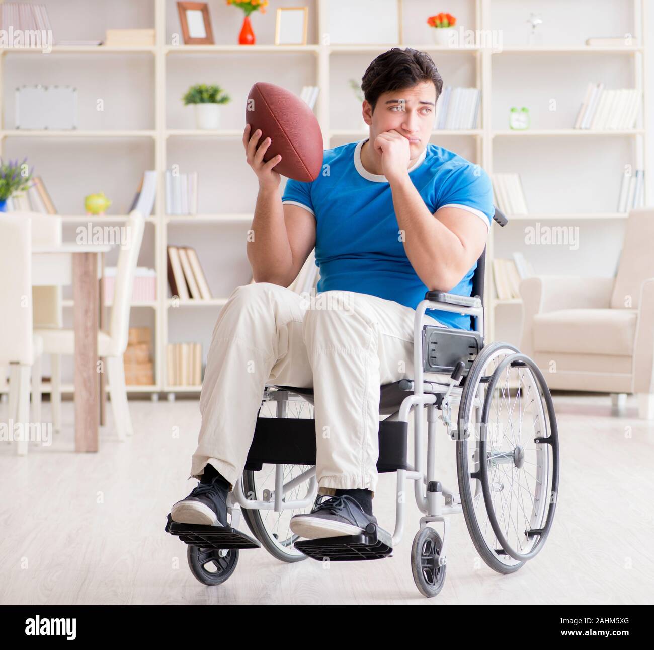 The young man american football player recovering on wheelchair Stock ...