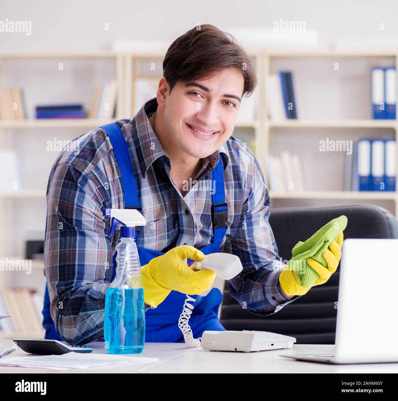 The male cleaner working in the office Stock Photo - Alamy