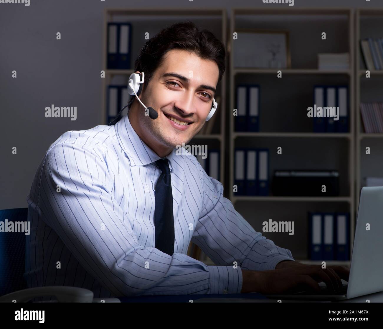 The call center operator talking to customer during night shift Stock ...