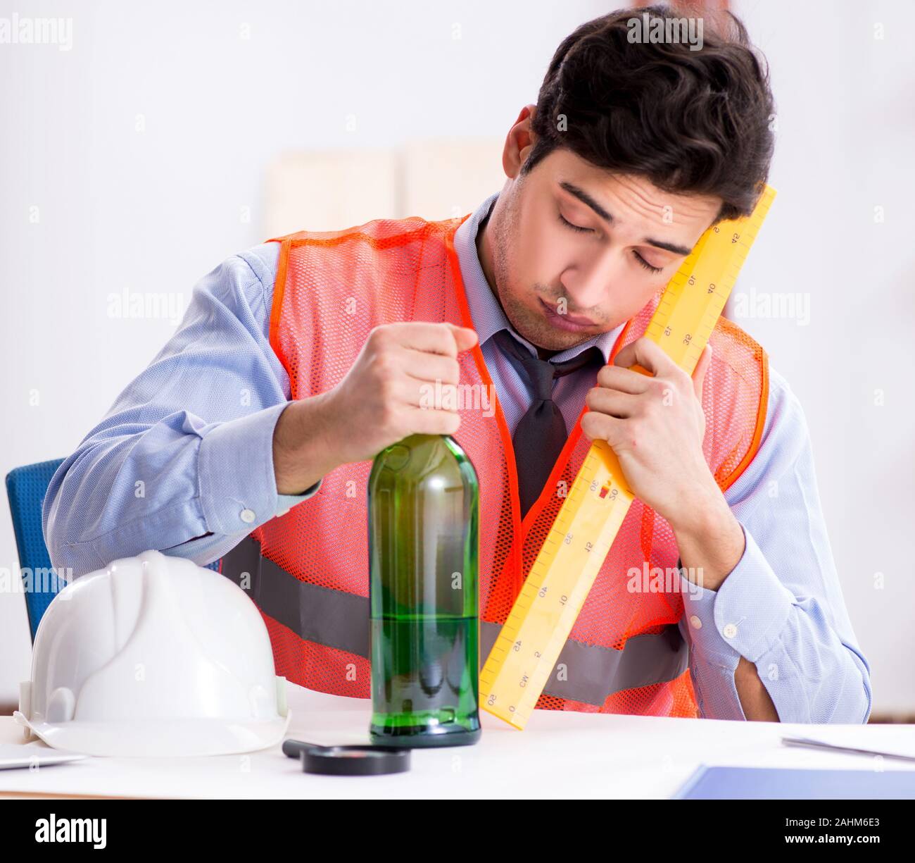 The drunk engineer working in the workshop Stock Photo - Alamy