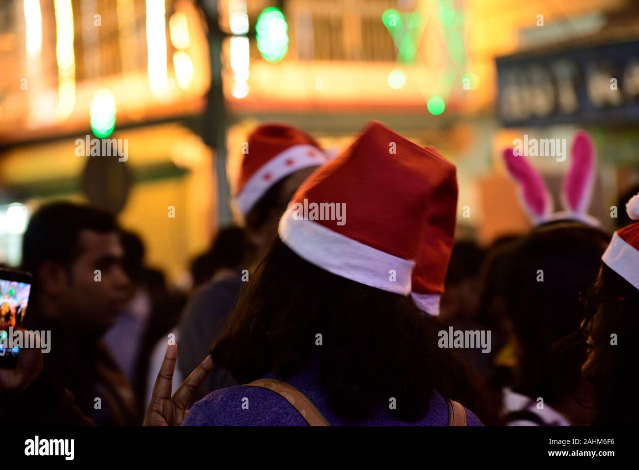 Girl is celebrating Christmas in a street during Christmas day at ...