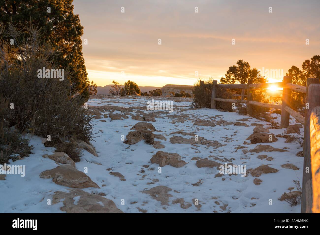 Sunrise over a winter snow covered hiking path in the Grand Canyon ...
