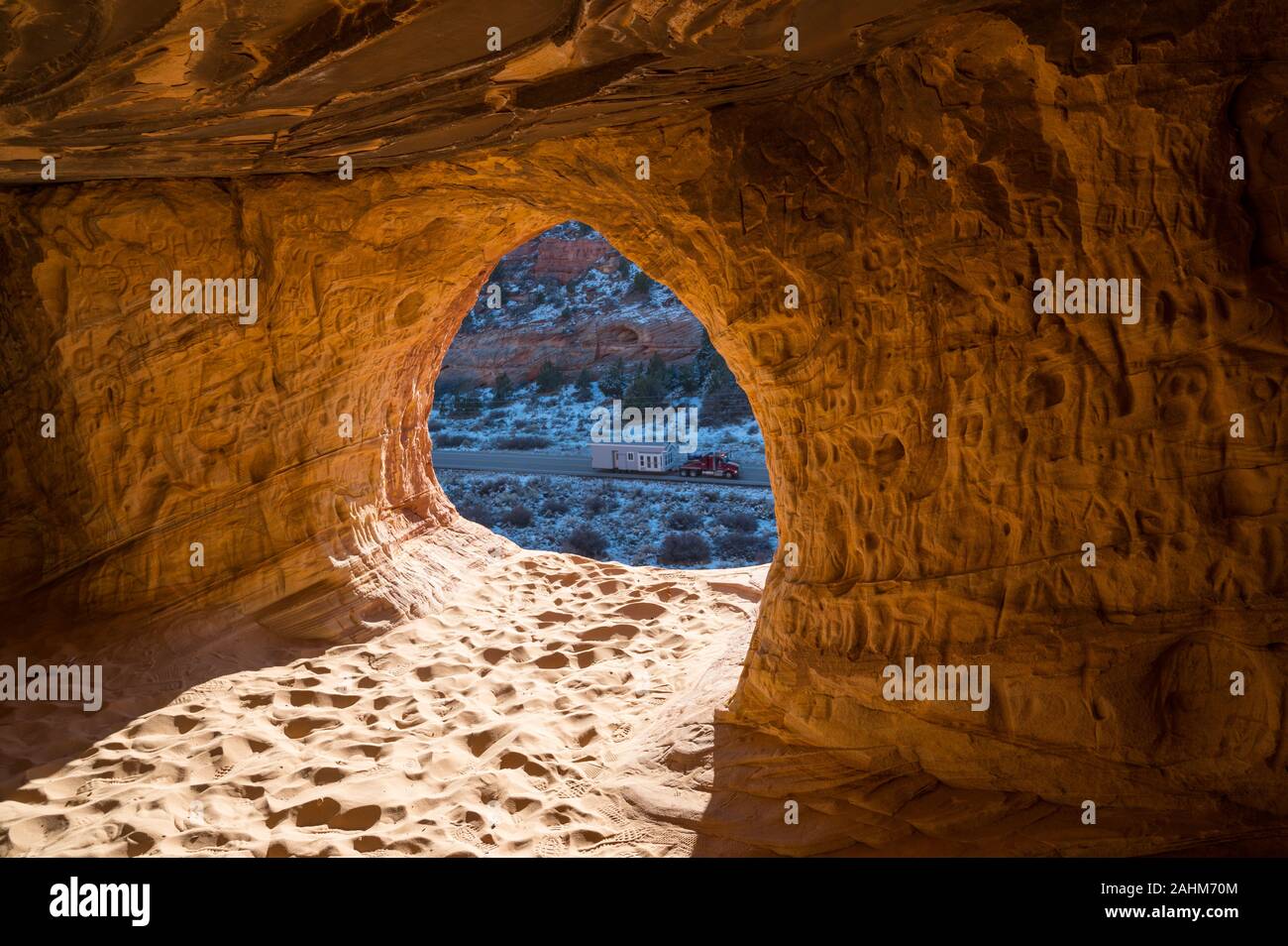 Truck pulling trailer, seen from the Sand caves eroded in the Sandstone ...