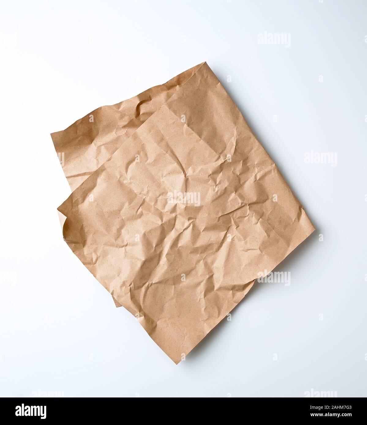 folded sheet of brown craft paper for packaging on a white background ...