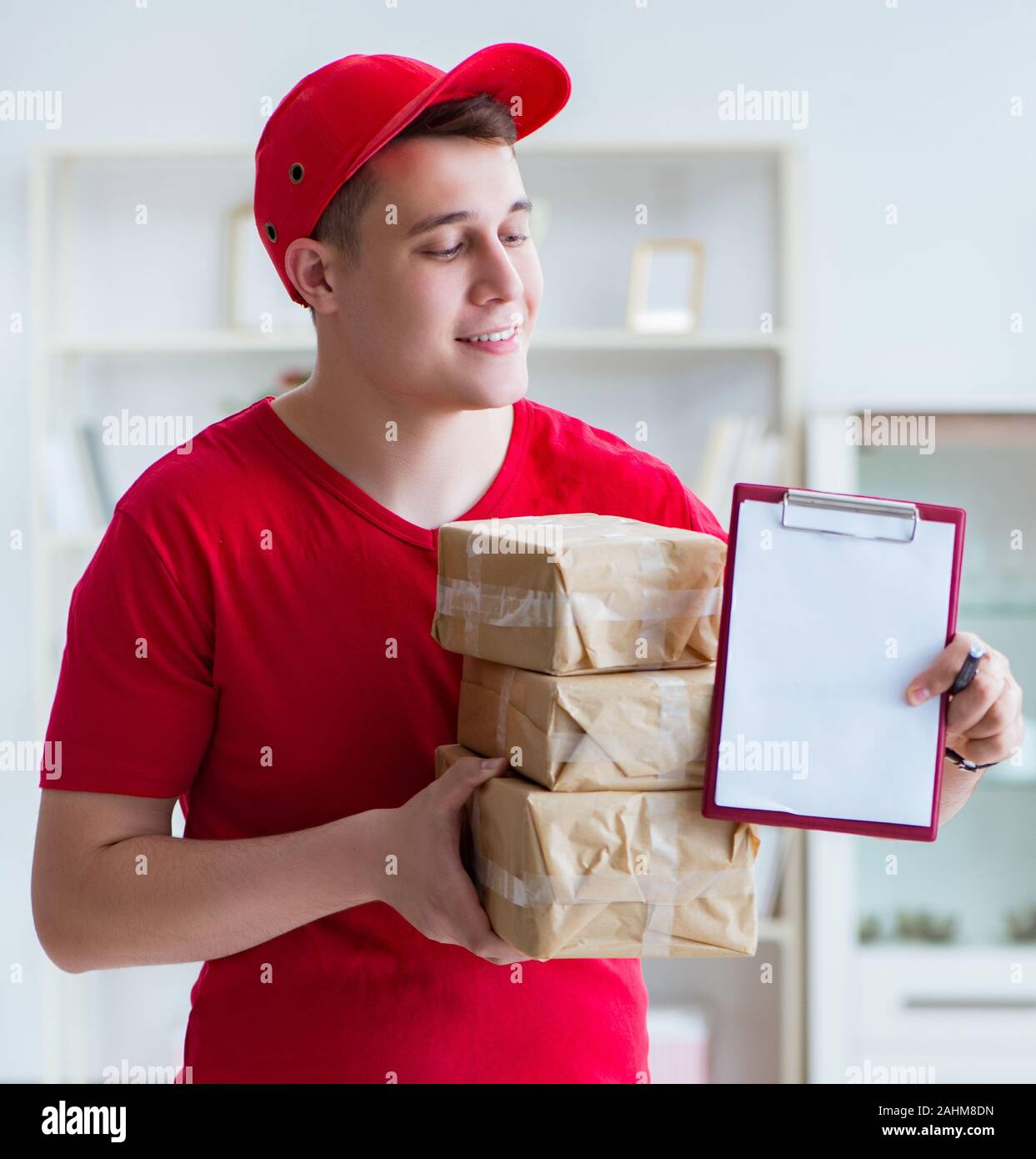 The post man delivering a parcel package Stock Photo - Alamy
