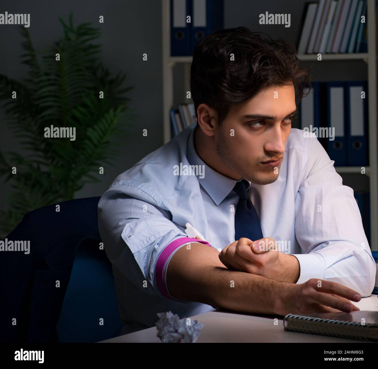 Employee relieving stress from overtime with drugs narcotics Stock ...