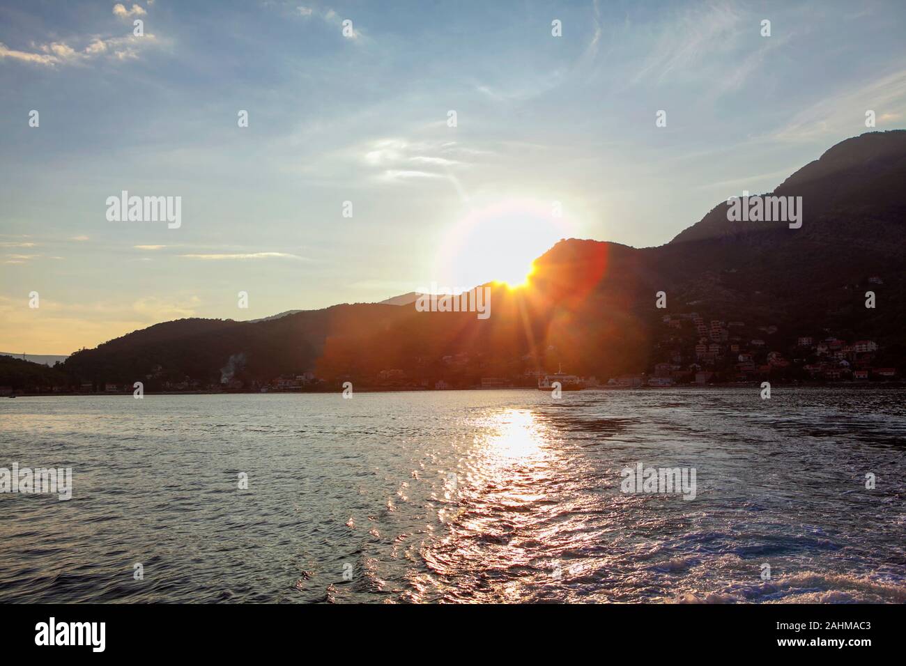sun over the mountain and sea Stock Photo - Alamy