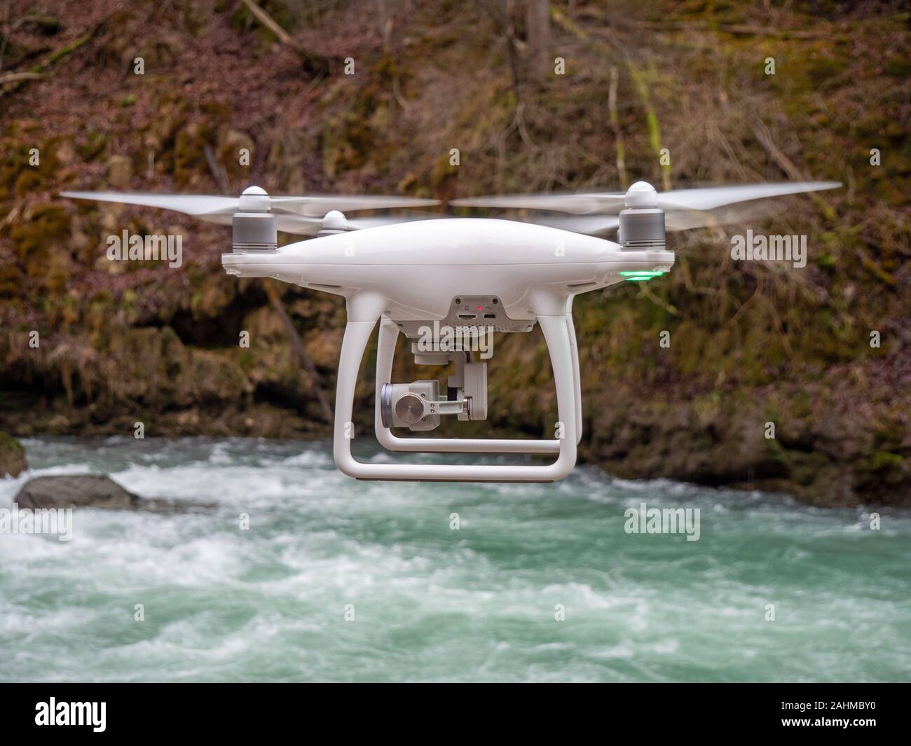 A drone hover in flight in front of the camera with landing lights ...