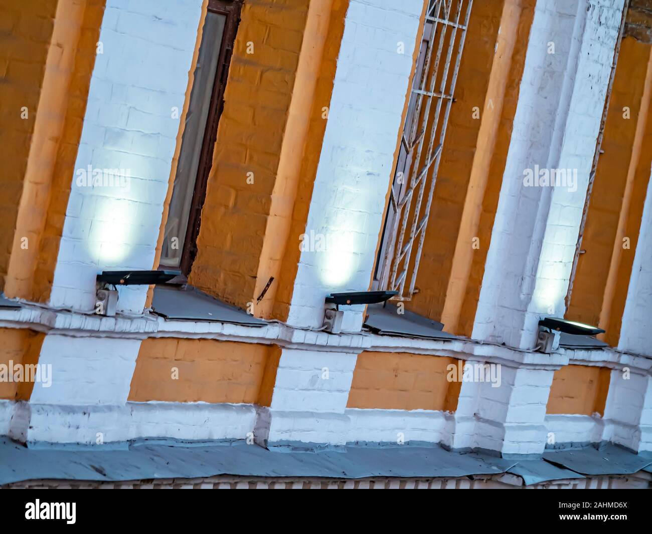 Evening street illumination of the city building. Background image ...