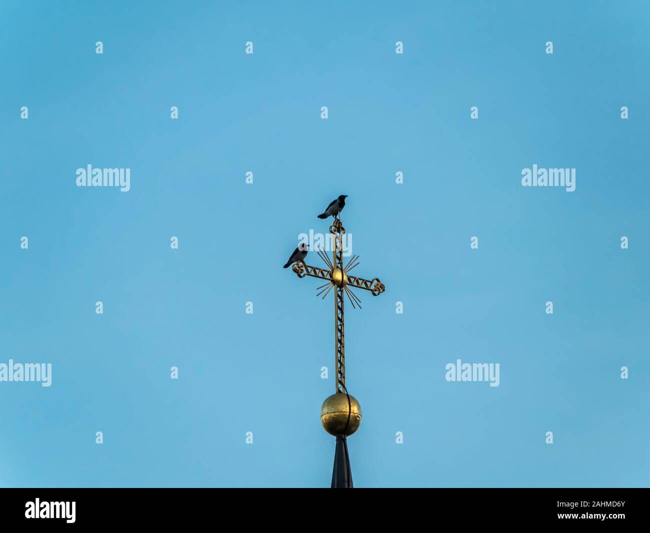 Crows birds on the Orthodox cross with a blue sky background for text ...
