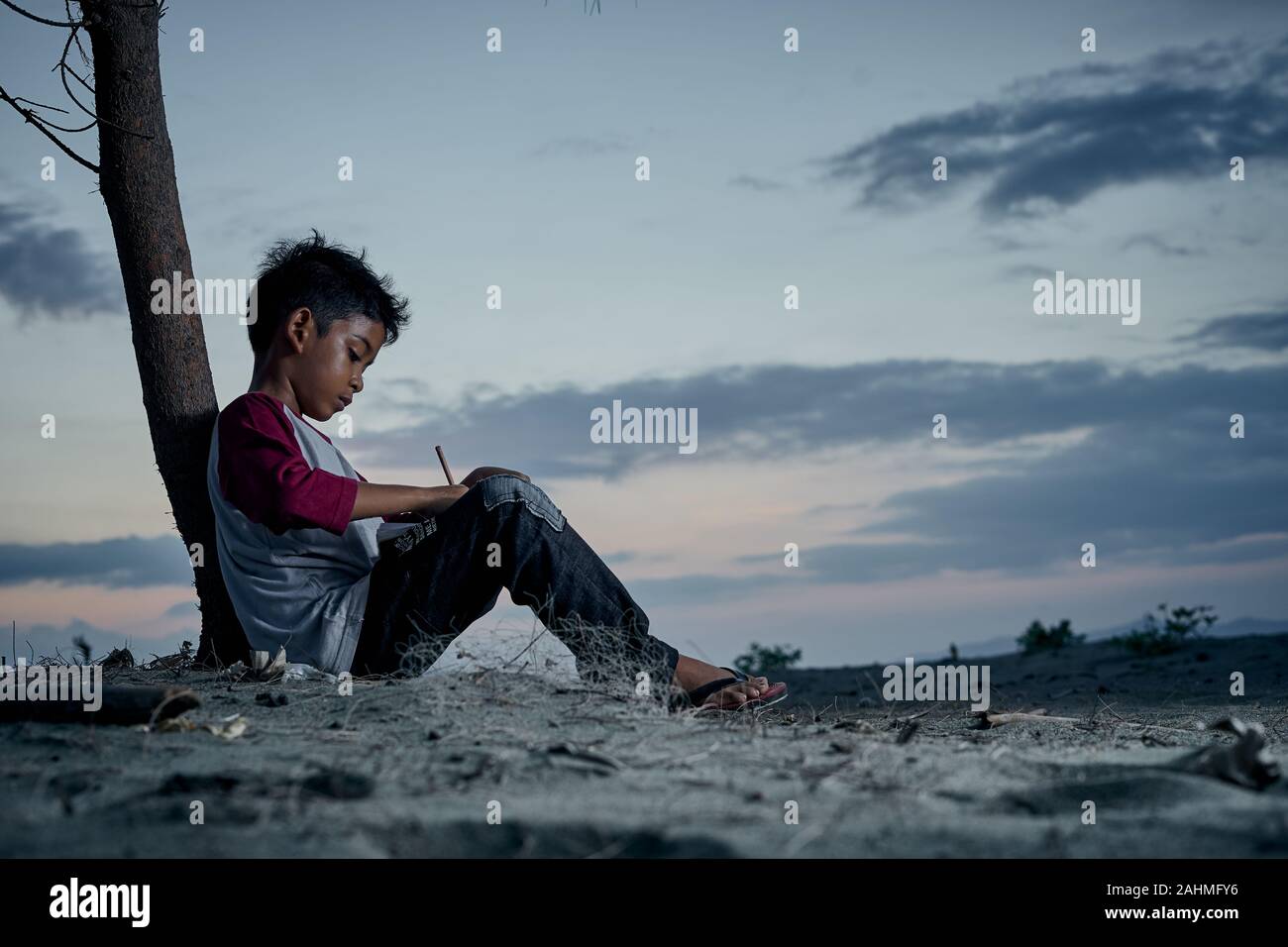 Smart boy doing homework outdoor under the sky at night Stock Photo - Alamy
