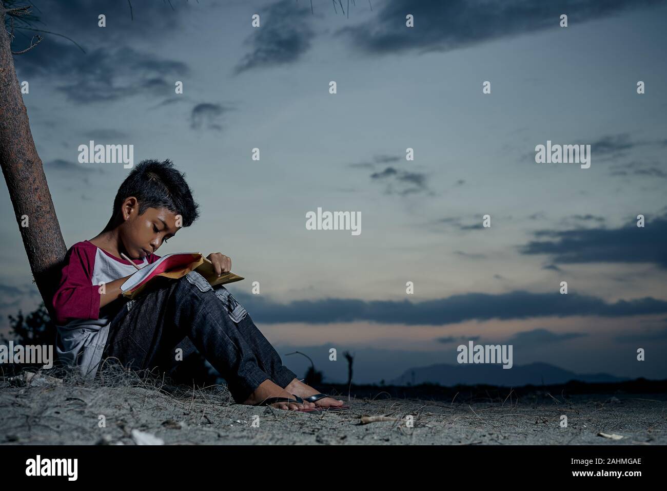 Smart boy doing homework outdoor under the sky at night Stock Photo - Alamy