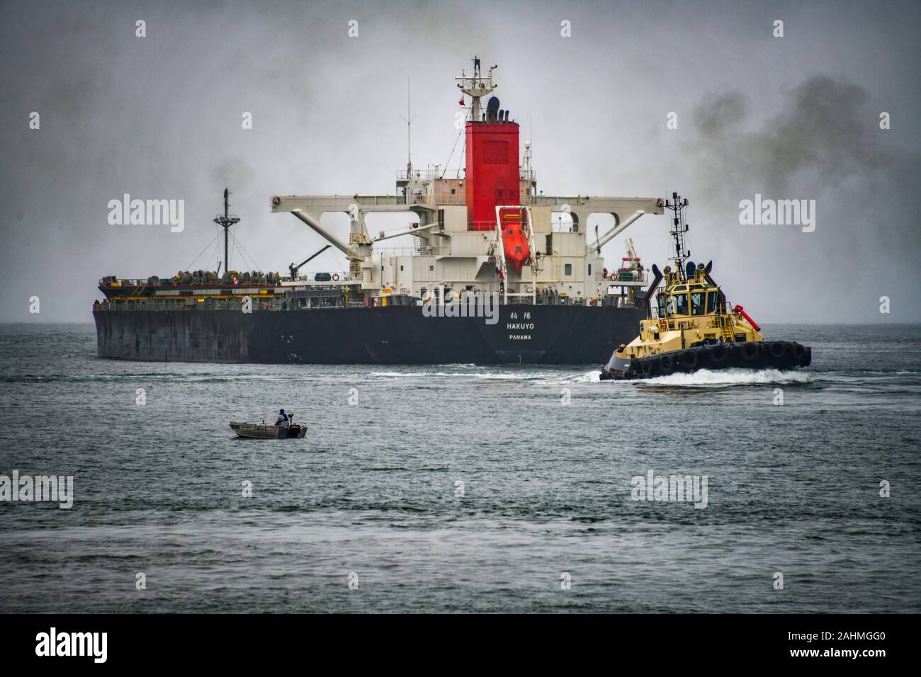 Coal Bulk Carrier with Tugboats Leaving Port of Newcastle with small ...