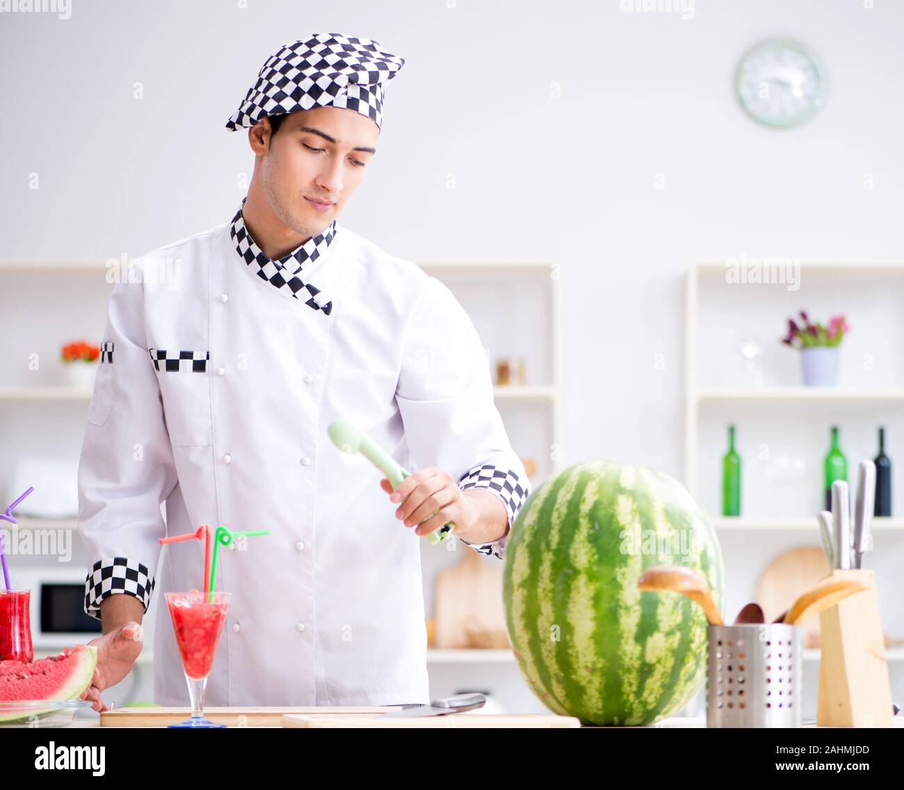 The male cook with watermelon in kitchen Stock Photo - Alamy