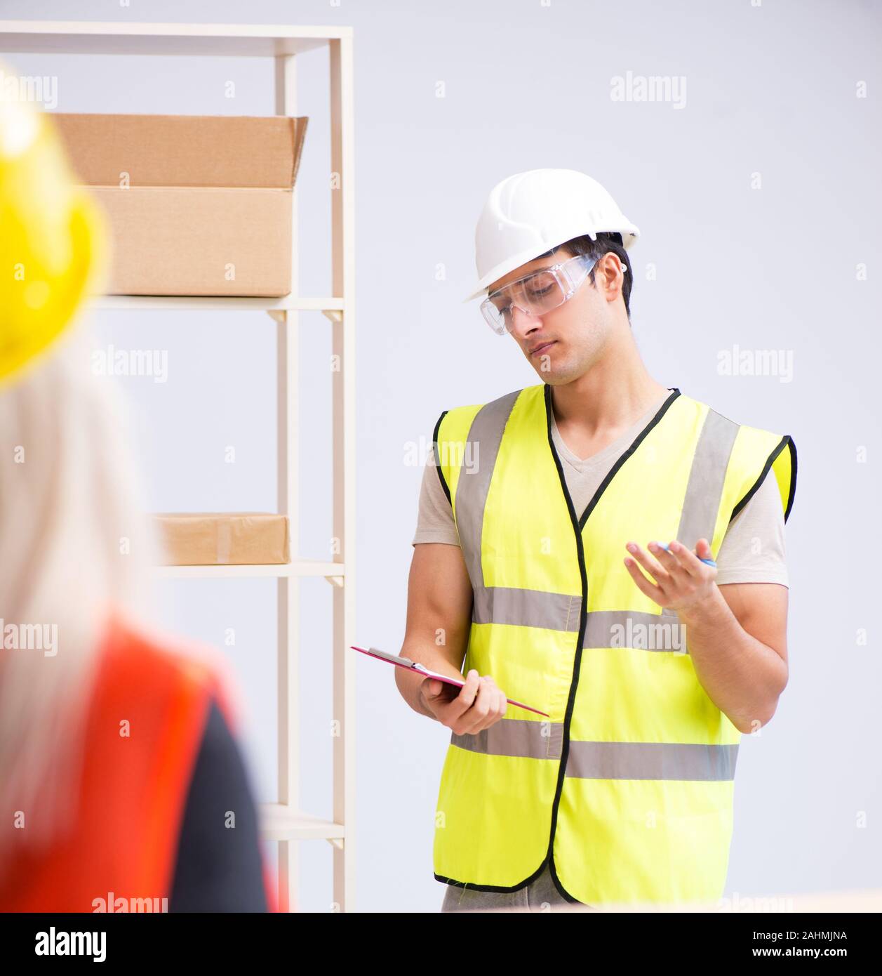 The delivery contractor delivering boxes to office Stock Photo - Alamy