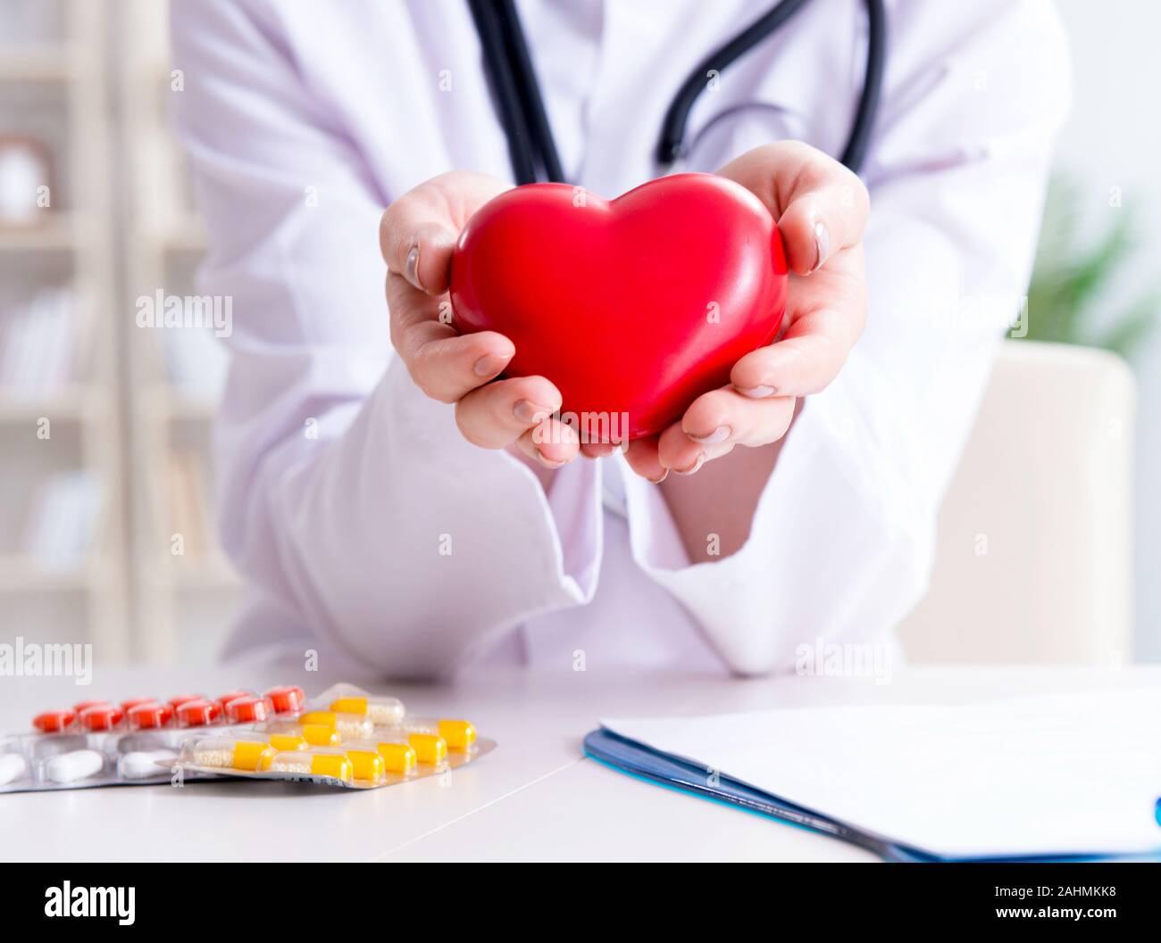 The doctor cardiologist with red heart in the hospital Stock Photo - Alamy