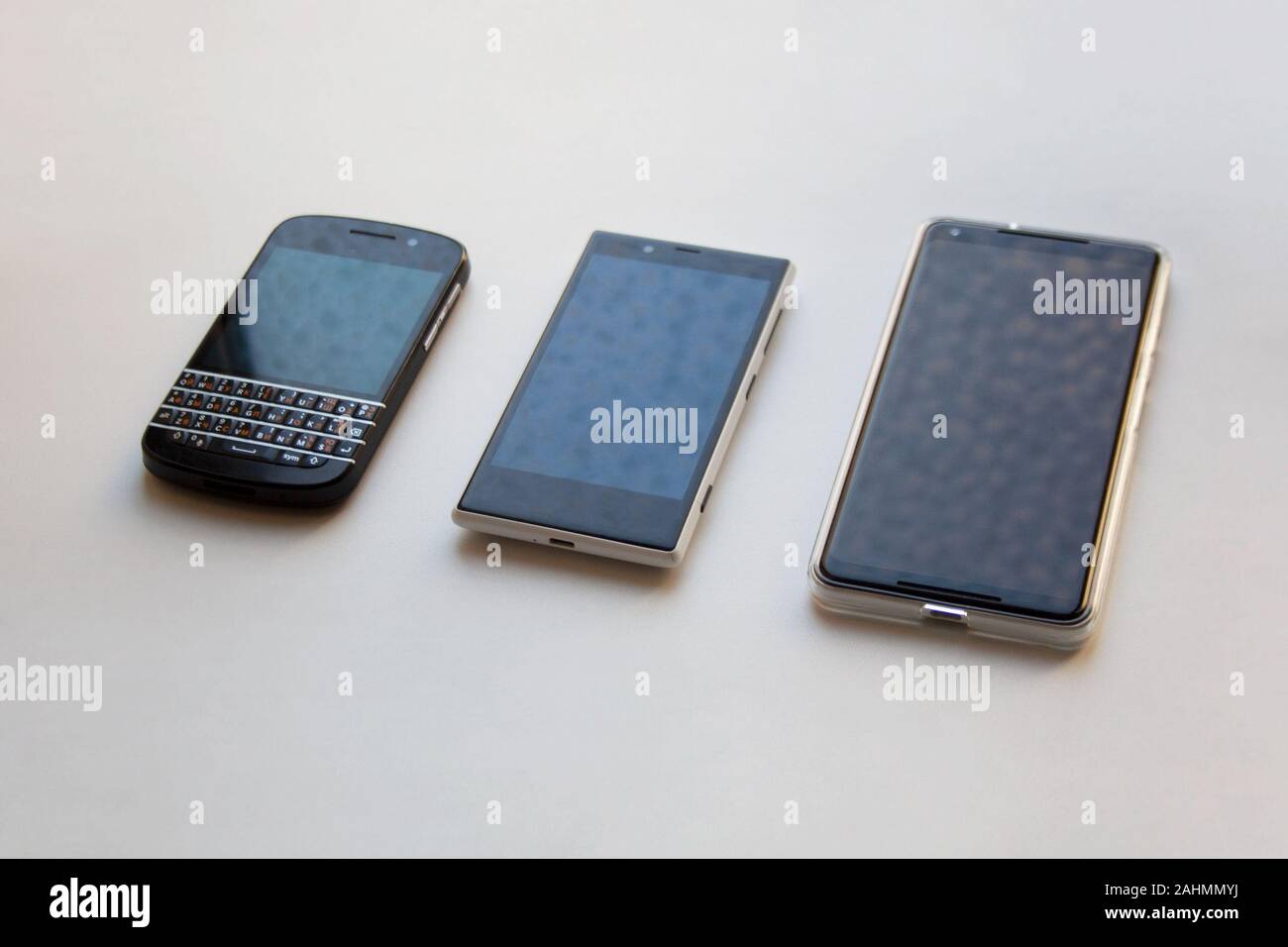 Three mobile phones isolated on white background Stock Photo - Alamy