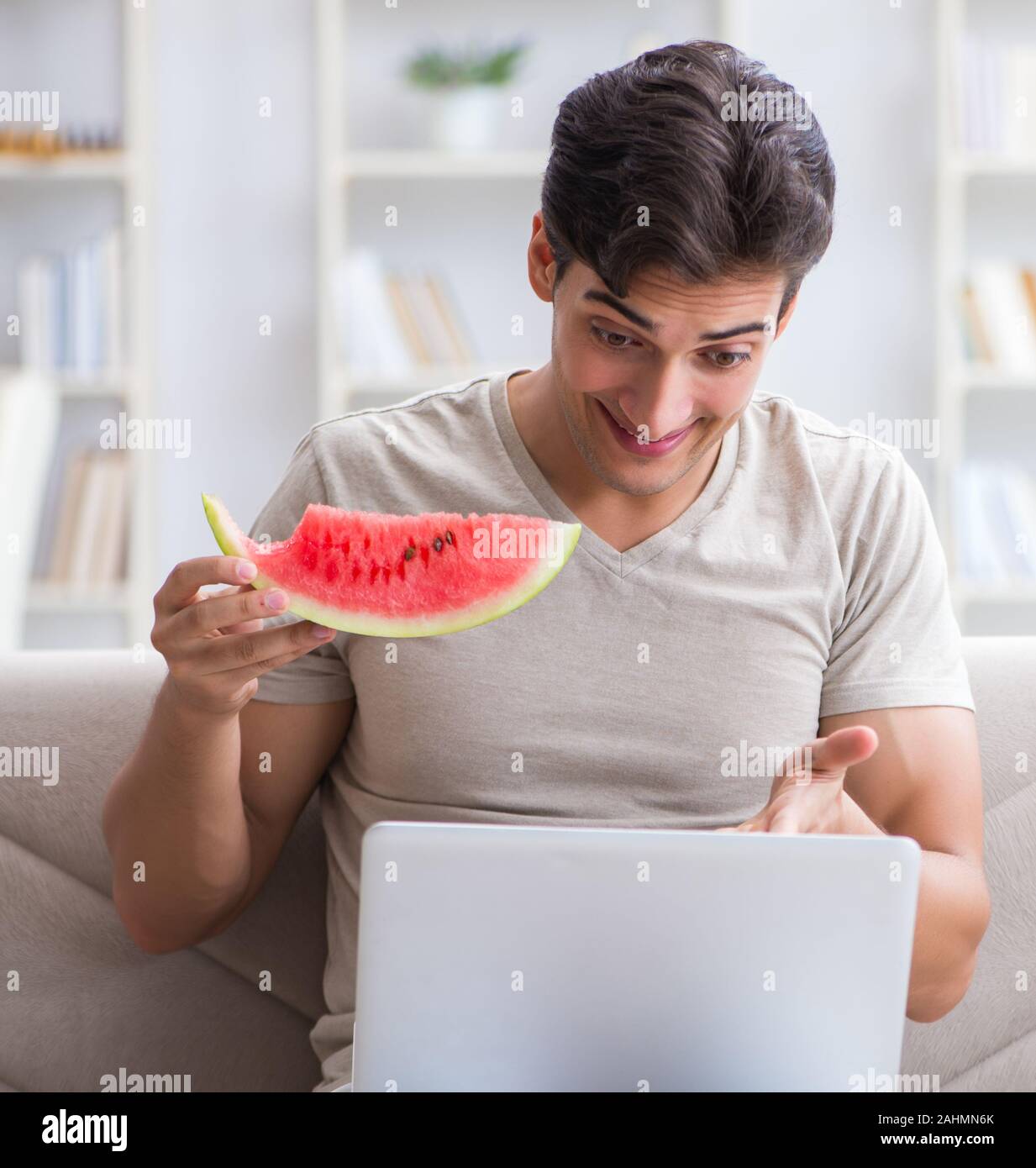 The man eating watermelon at home Stock Photo - Alamy