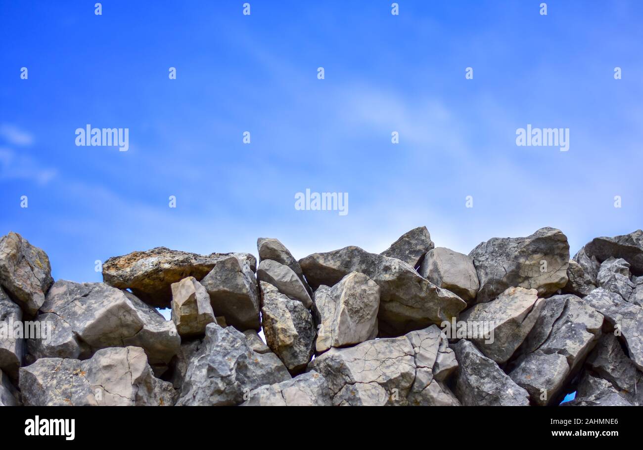 Stone Wall. Handmade, fence. Stone wall with a blue sky with clouds ...
