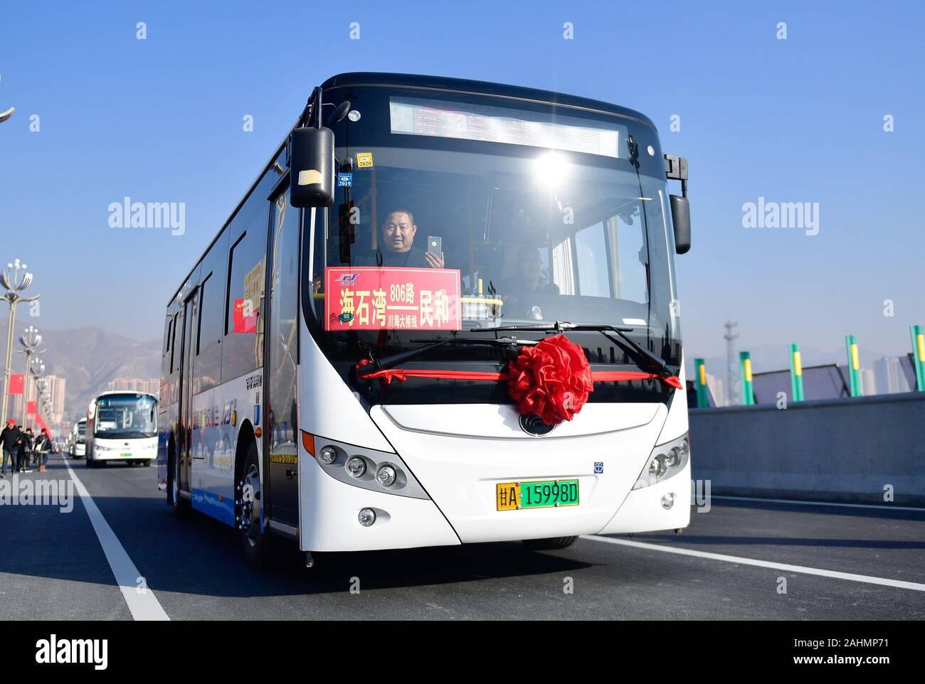 Haidong, China. 31st Dec, 2019. A bus runs on the Chuanhai Bridge over ...