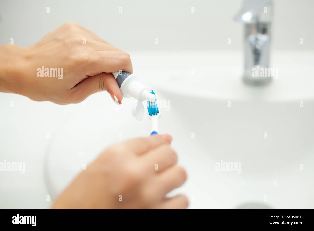 Close up hands woman use toothbrush in light bathroom Stock Photo - Alamy