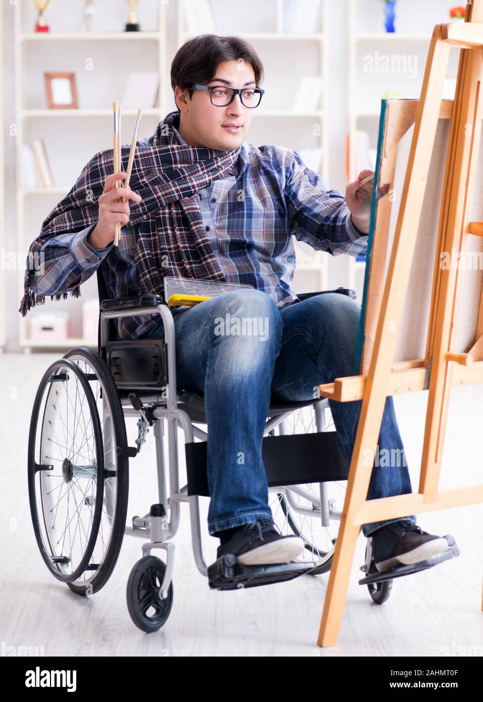 The disabled artist painting picture in studio Stock Photo - Alamy