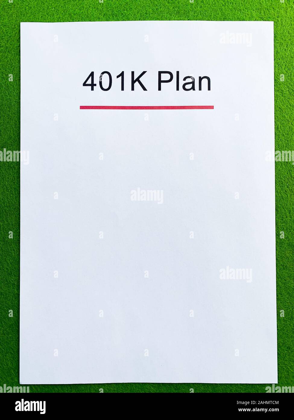 Paper with 401k plan on green background Stock Photo - Alamy