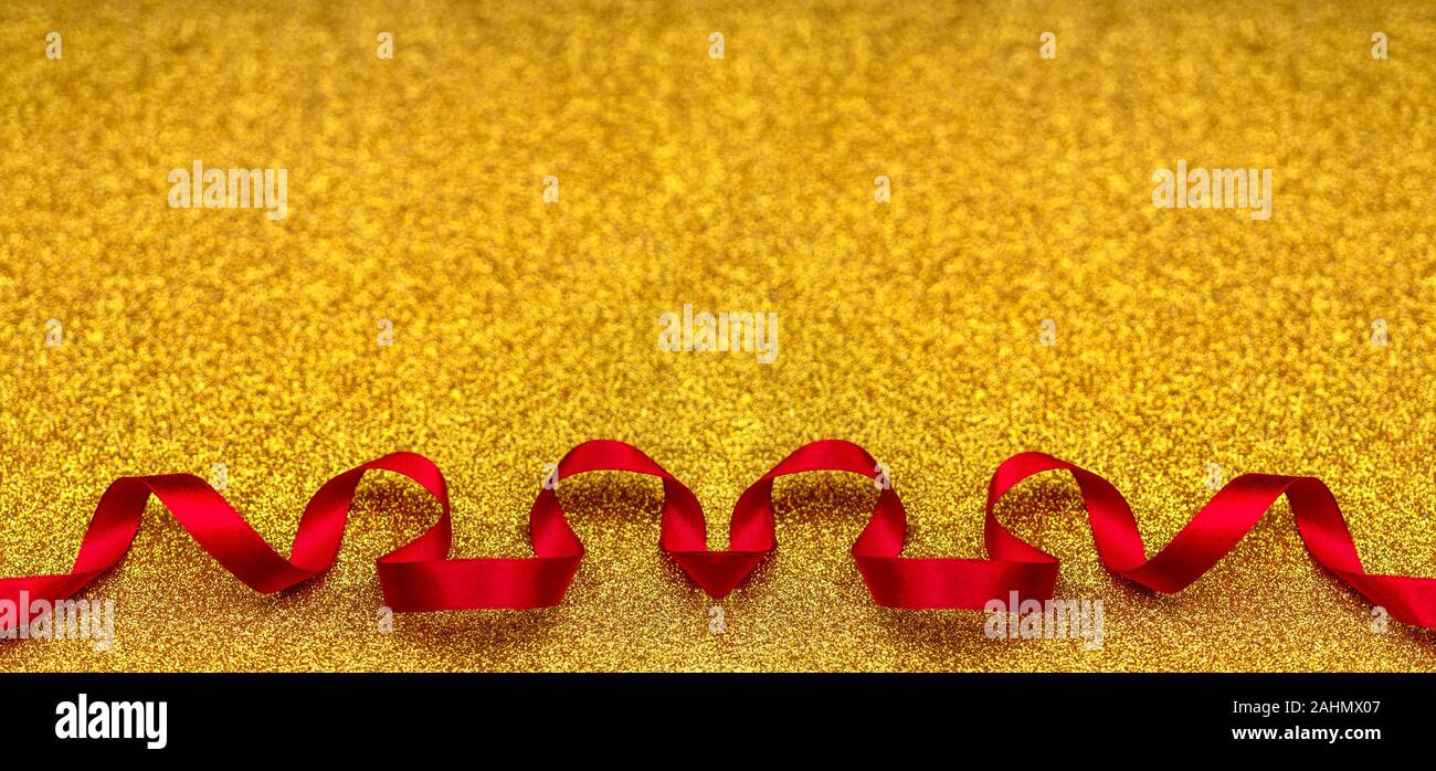 Red wavy ribbon on gold background. Holiday decoration. Valentine's Day ...
