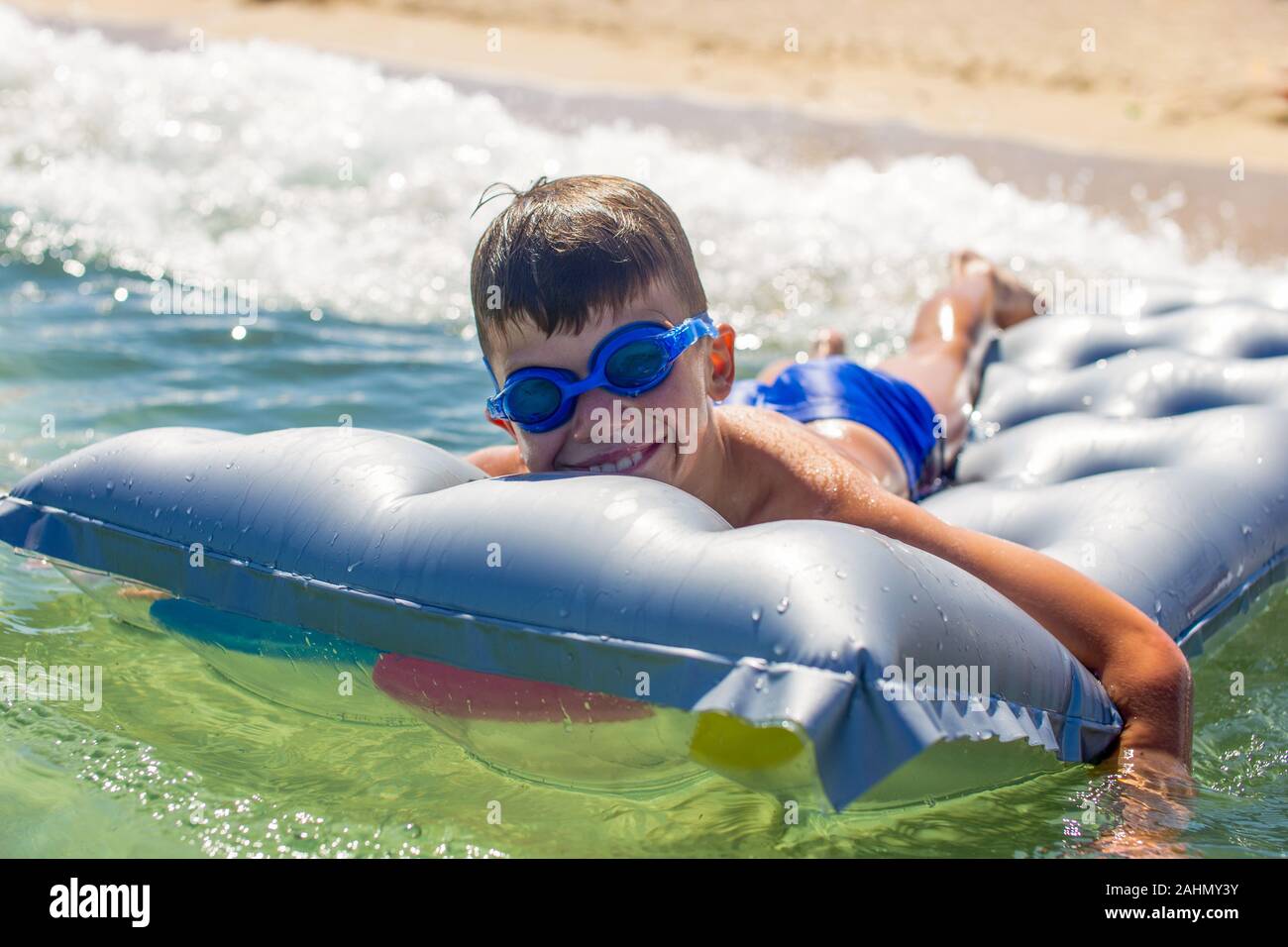Boy Lying On Inflatable Mattress High Resolution Stock Photography and ...